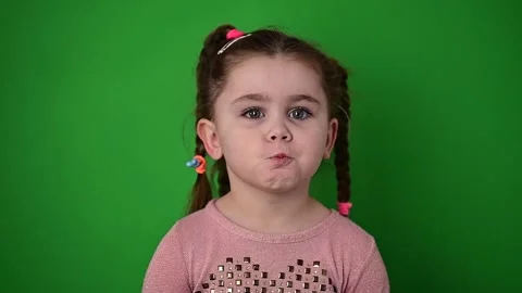 Angry little girl, green background, | Stock Video | Pond5