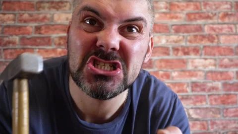 Angry man with a hammer swears 4K | Stock Video | Pond5