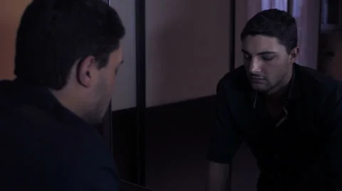 Angry man looks in mirror screaming | Stock Video | Pond5