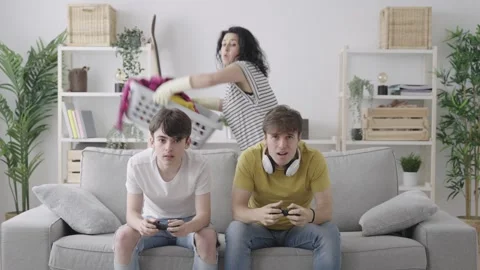 Angry mother throwing clothes to boys ig... | Stock Video | Pond5