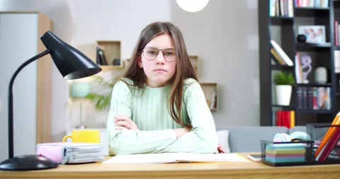 Angry sad schoolgirl trying to do homewo... | Stock Video | Pond5