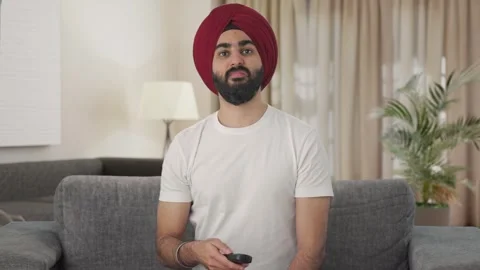 Angry Sikh Indian man Indian watching TV | Stock Video | Pond5