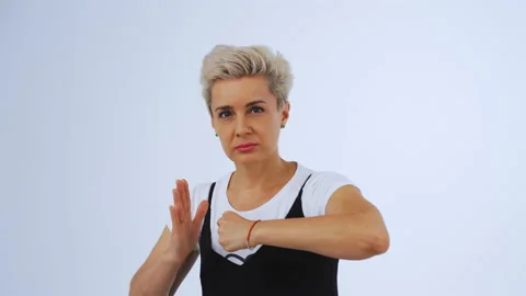 Angry woman with a short haircut punches... | Stock Video | Pond5