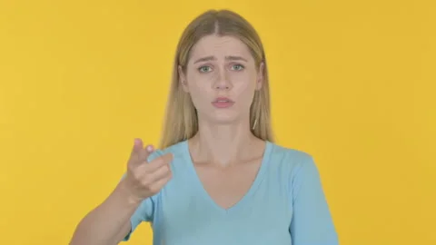 Angry Young Woman Arguing on Yellow Back... | Stock Video | Pond5