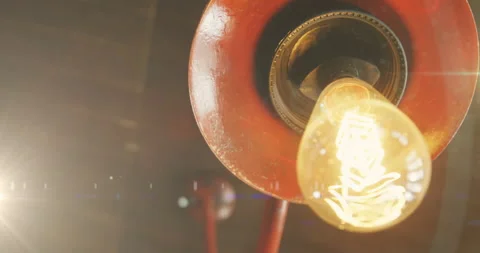 Animation of lit light bulb hanging from... | Stock Video | Pond5