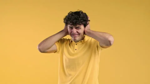 Annoyed curly man with shut ears on yell... | Stock Video | Pond5