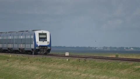 An approaching train in the green fields... | Stock Video | Pond5