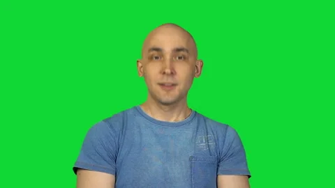 Approving bald man on green background | Stock Video | Pond5