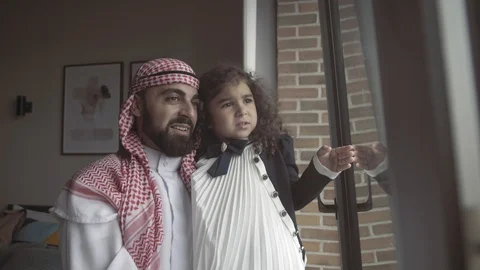An Arab father in traditional dress hold... | Stock Video | Pond5