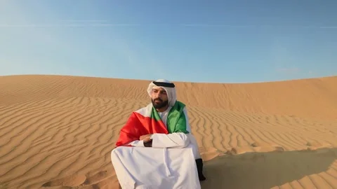 Arab man sitting with the UAE flag in th... | Stock Video | Pond5
