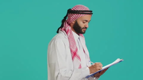 Arab man writing letter on papers | Stock Video | Pond5