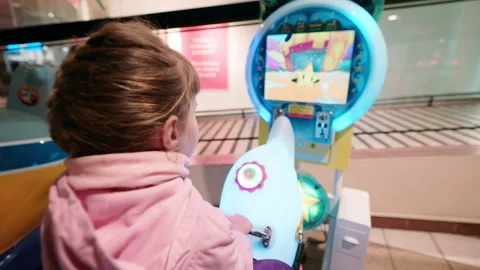 Arcade game: Cute girl is having fun on ... | Stock Video | Pond5