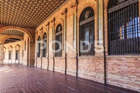Photograph: The arcades at Sapin Square lined with arched windows with ...