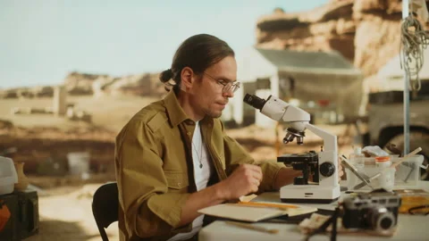 Archaeologist Uses Microscope | Stock Video | Pond5