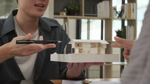 Architect man pointing at house model, e... | Stock Video | Pond5