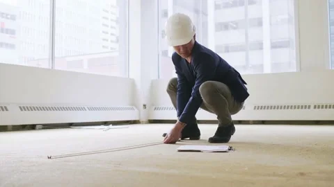 Architect measuring empty office space | Stock Video | Pond5