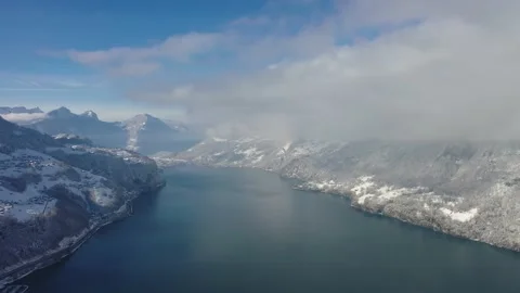 Areal flight over a clear blue lake and ... | Stock Video | Pond5