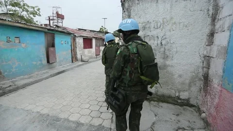 Armed soldiers moving cautiously along ... | Stock Video | Pond5