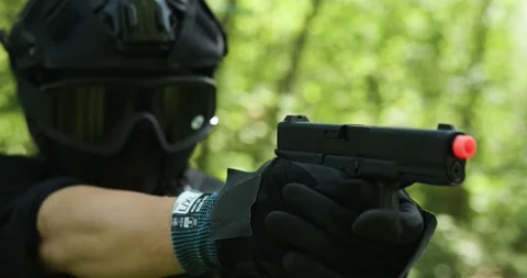 Army guy looking down his pistol sights ... | Stock Video | Pond5