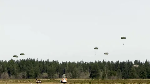 Army parachuter's hitting the ground | Stock Video | Pond5