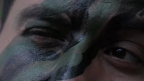 Army soldier applying face paint | Stock Video | Pond5