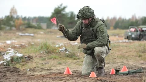 Army soldier marking IED in ground with ... | Stock Video | Pond5