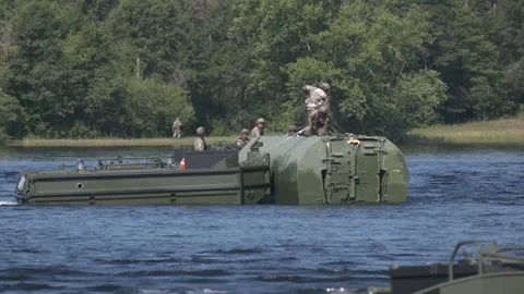 Army soldiers attach floating pontoon br... | Stock Video | Pond5