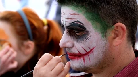 Artist applies horror make-up for man | Stock Video | Pond5