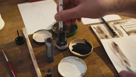 artist dipping a pen into ink, then test... | Stock Video | Pond5