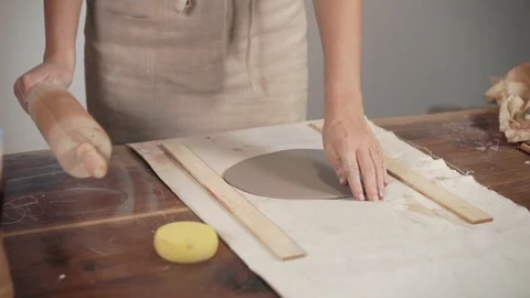 Artist is unrolling clay on table in wor... | Stock Video | Pond5