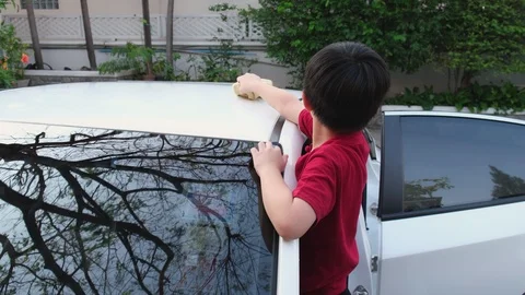An Asia boy carefully to clean dirt from... | Stock Video | Pond5