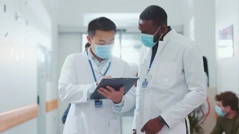Asian and african doctors discussing new... | Stock Video | Pond5