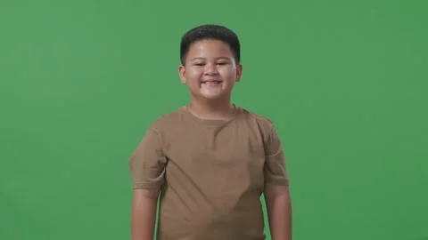 An Asian Boy Warmly Smiling On Green Scr... | Stock Video | Pond5