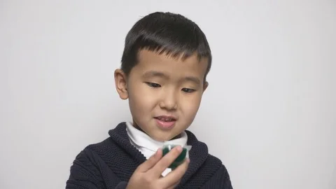 Asian child holds washing powder pod in ... | Stock Video | Pond5