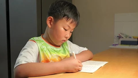 An Asian child is writing Chinese charac... | Stock Video | Pond5