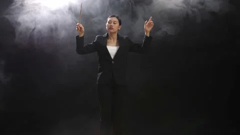 Asian Conductor Woman Holding A Baton Cl... | Stock Video | Pond5
