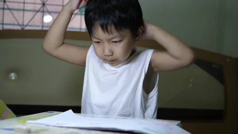 Asian cute child boy scratch head by han... | Stock Video | Pond5