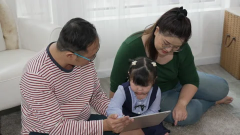 Asian Family Watching Cartoon From Compu... | Stock Video | Pond5