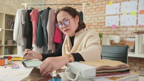 Asian female fashion designer works by i... | Stock Video | Pond5