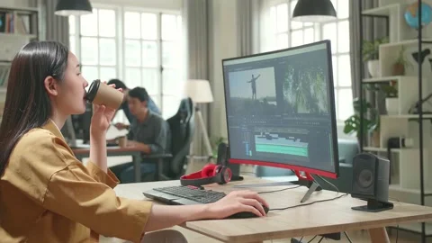 Asian Female Video Editor Works And Drin... | Stock Video | Pond5