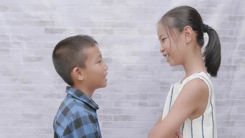 ASIAN GIRL TALKING TO BOY, KID SPEAKING ... | Stock Video | Pond5
