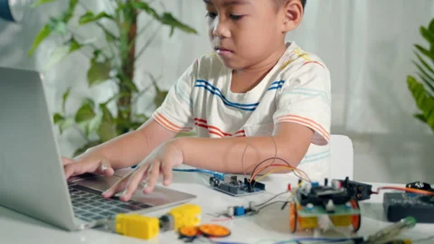 Asian kid boy learns coding and programm... | Stock Video | Pond5