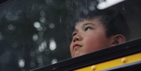 Asian kid on school bus smiling out the ... | Stock Video | Pond5