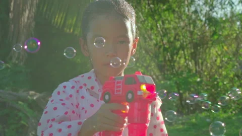 Asian little girl in rainwear is playing... | Stock Video | Pond5