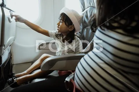 Asian little girls push the folding table button while sitting Stock ...