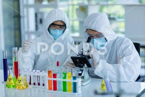 Asian male female professional scientists colleague in ppe full ...