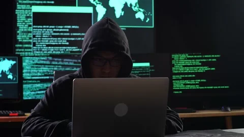 Asian Male Hacker In A Hood Works On A L... | Stock Video | Pond5