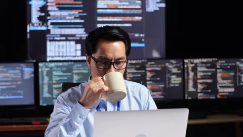 Asian Male Programmer Drinking Coffee Wh... | Stock Video | Pond5