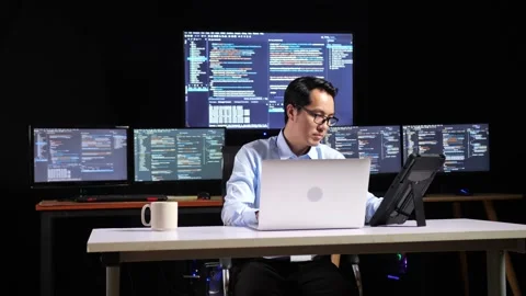 Asian Male Programmer Looking At Tablet ... | Stock Video | Pond5