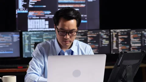 Asian Male Programmer Looking At Tablet ... | Stock Video | Pond5